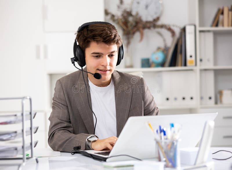 Office Worker Man is Working at Computer and Talking by Headset with ...
