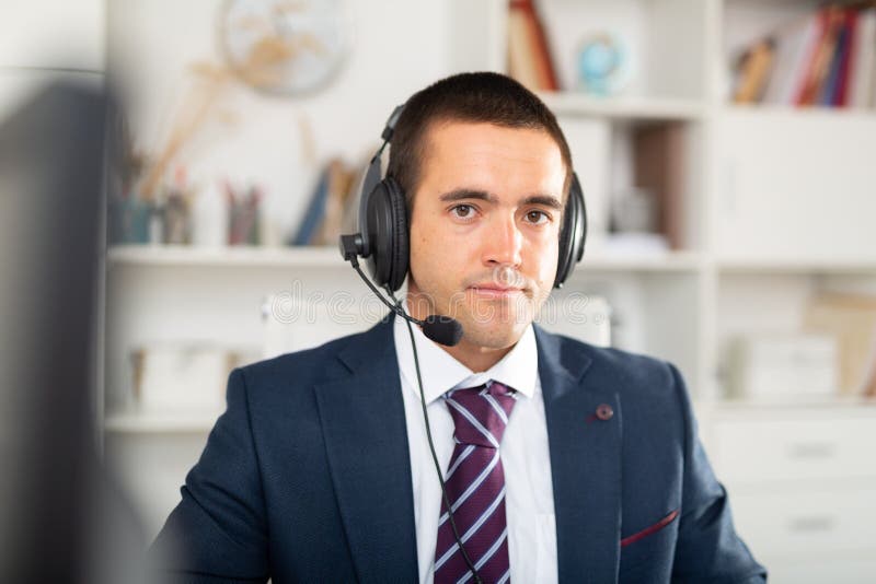 Office Worker Man is Working at Computer and Talking by Headset with ...