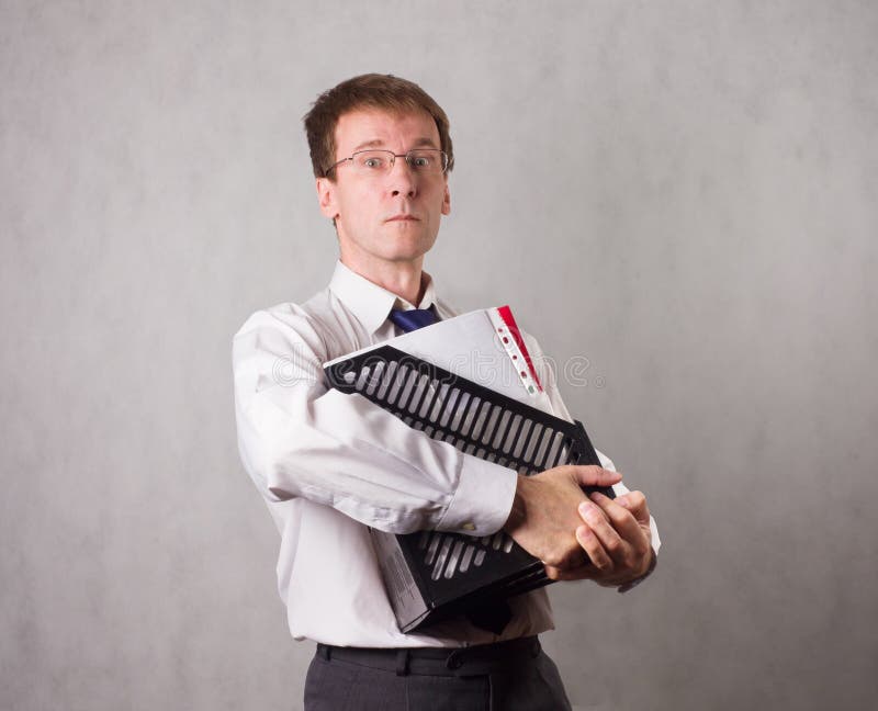 An Office Worker with Many Accounting Documents in His Hands is ...