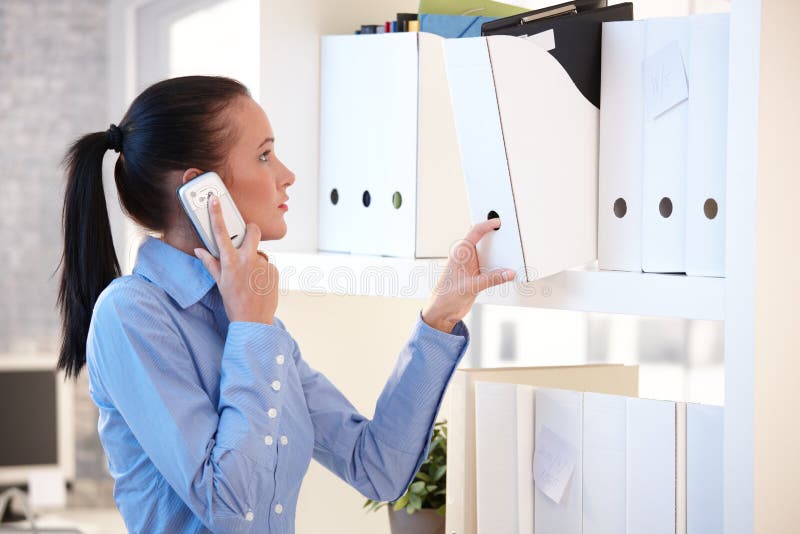 Office Worker on Mobile Phone Choosing File Folder Stock Image - Image ...