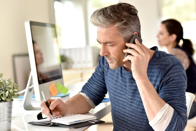 Office worker on phone stock photo. Image of computer - 68432694