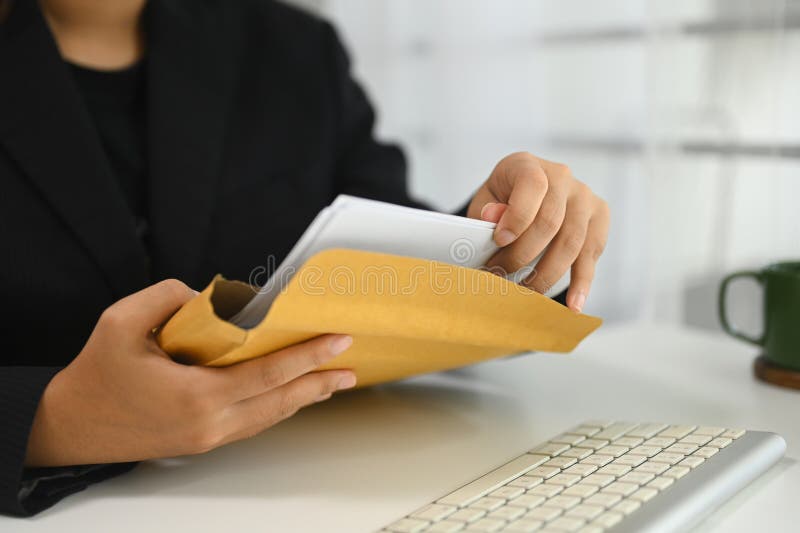 Office Worker Preparing Documents in Envelope for Business Transactions ...