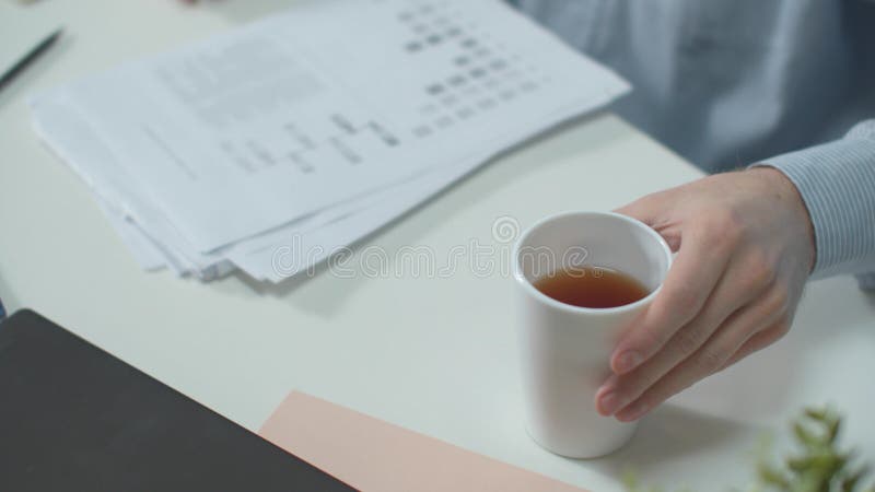 Office Worker Puts Documents Down and Drinks Tea Stock Image - Image of ...