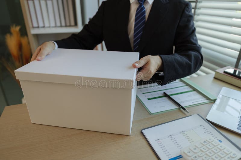 An Office Worker is Putting Important Documents in Boxes To Prevent ...