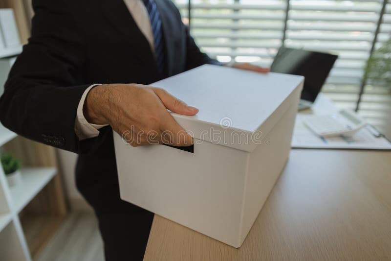 An Office Worker is Putting Important Documents in Boxes To Prevent ...