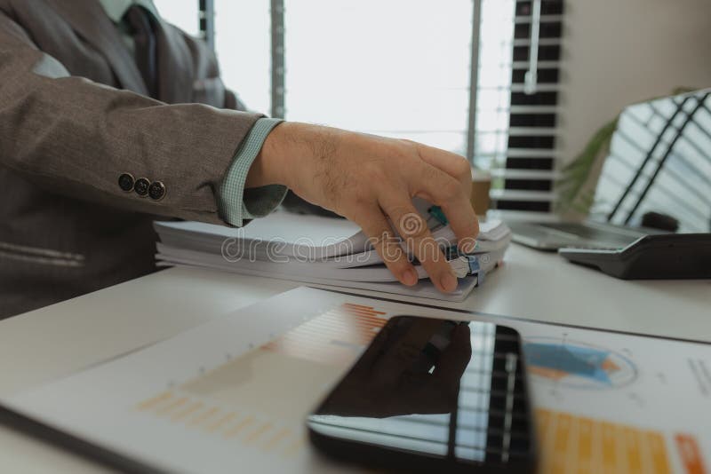 An Office Worker is Putting Important Documents Together To Keep ...