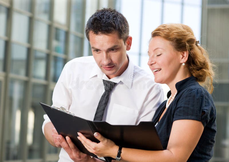 Co-Workers Reviewing Documents Stock Photo - Image of assistants ...