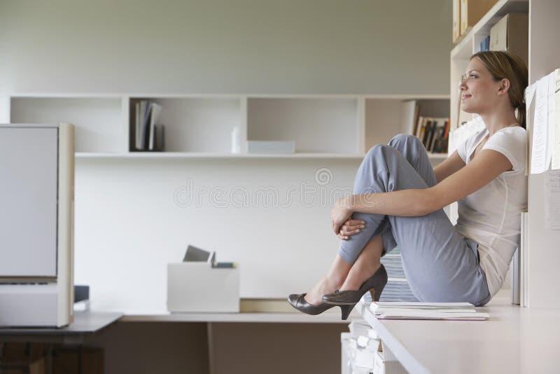 Office Worker Sitting on Bench in Office Side View Stock Photo - Image ...