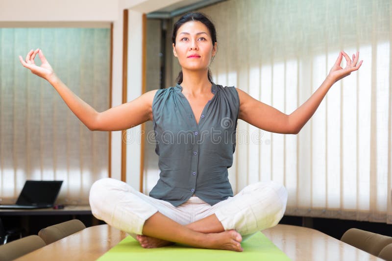 Office Worker Sitting in Yoga Lotus Pose on Table during Break Stock ...