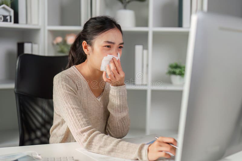 Office Worker Sneezing and Using Tissue while Working at Her Desk ...