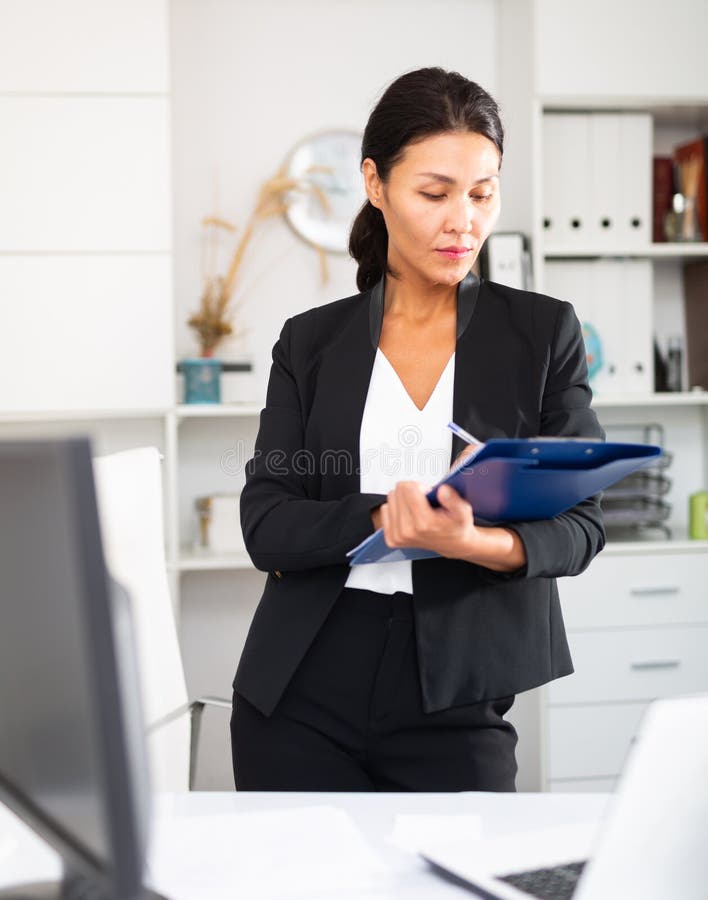 Office Worker is Standing with Documents before Signing it in Office ...