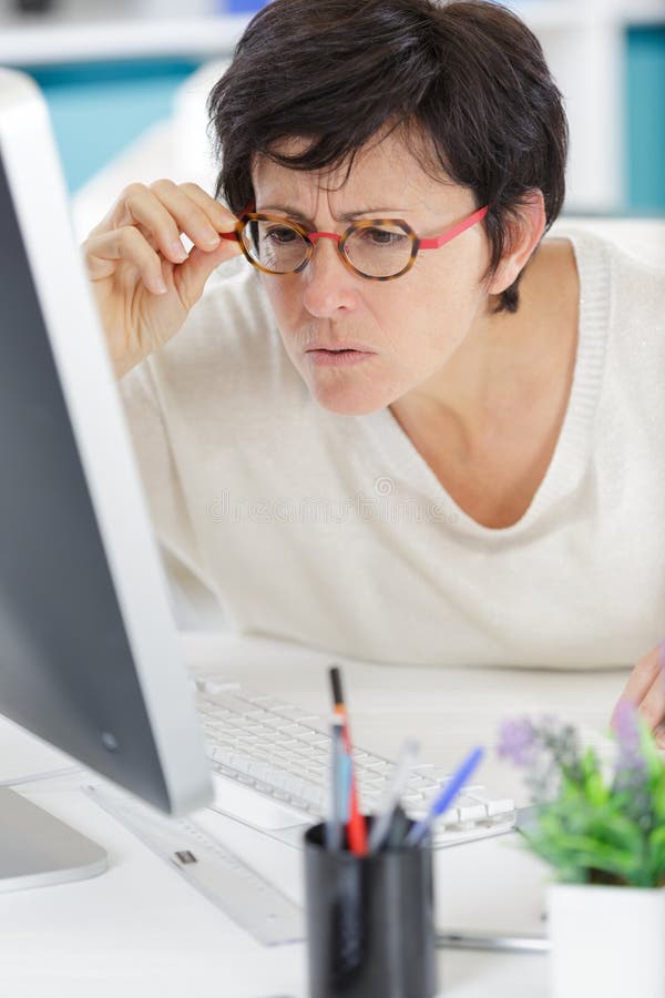 Office Worker Staring at Computer Screen and Adjusting Glasses Stock ...
