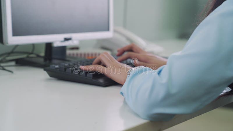 An Office Worker is Typing Text on a Computer Keyboard. Businesswoman ...