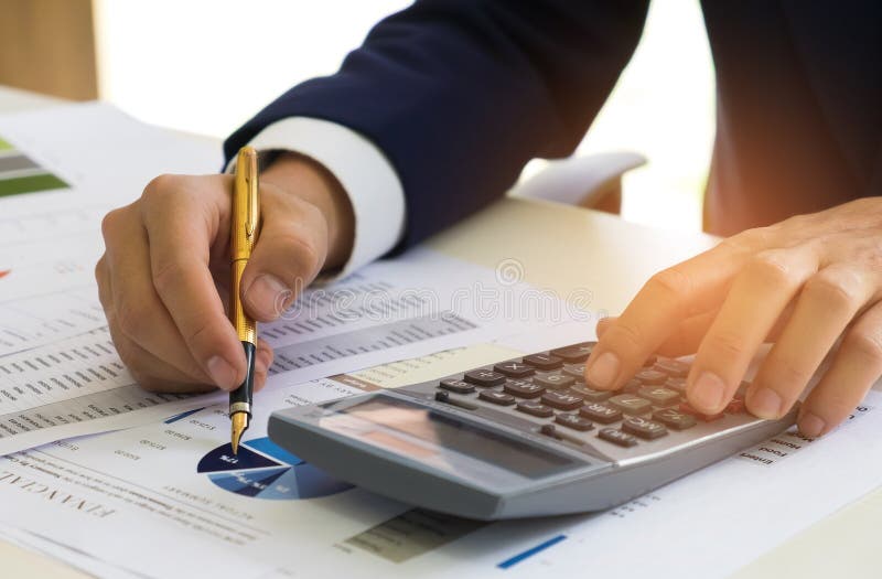 Office Worker is Using a Calculator,Pen in Hand Points To the Gr Stock ...