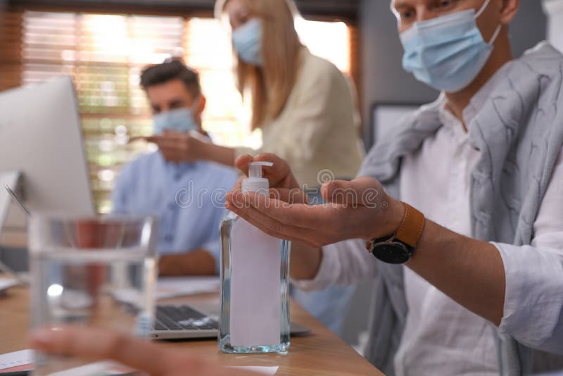 Office Worker Using Hand Sanitizer at Table, Closeup. Personal Hygiene ...