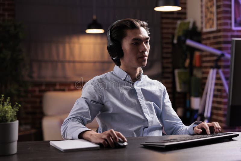 Office Worker Using Headphones and Working Stock Photo - Image of data ...