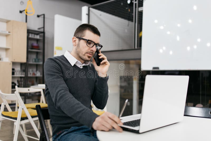 Office Worker Using Laptop while Talking on Phone Stock Photo - Image ...