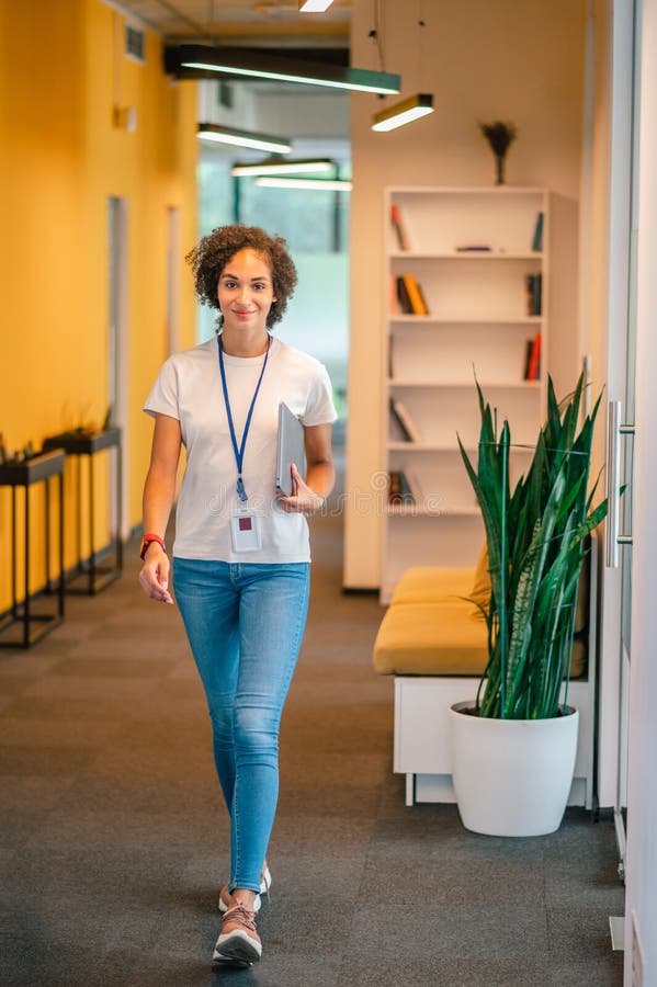 Office Worker Walking in the Office Corridor and Looking Contented ...