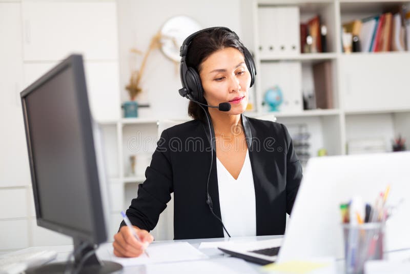 Office Worker Man is Working at Computer and Talking by Headset with ...