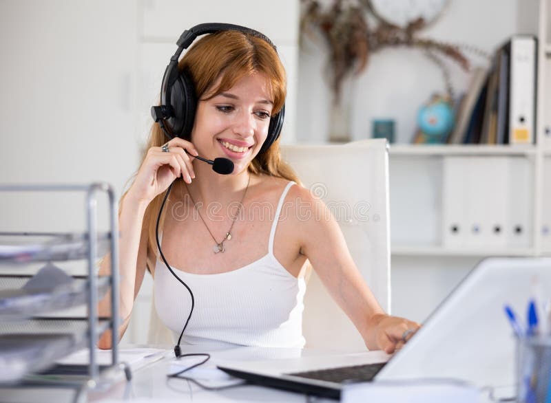 Office Worker Woman is Working at a Computer and Talking by Headset ...