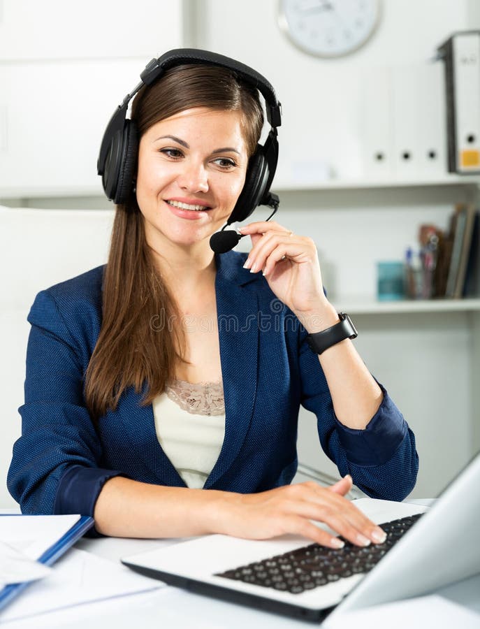 Office Worker Woman is Working at a Computer and Talking by Headset ...