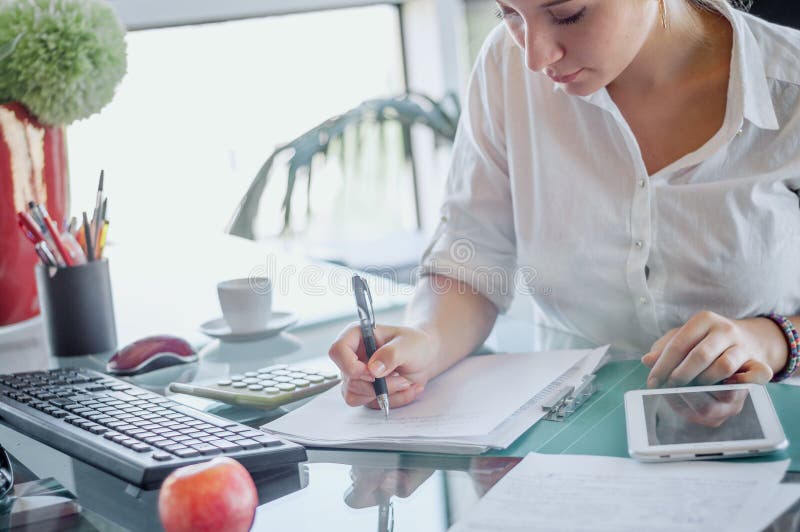Office Worker at Workplace. Girl Writing on Paper Stock Photo - Image ...