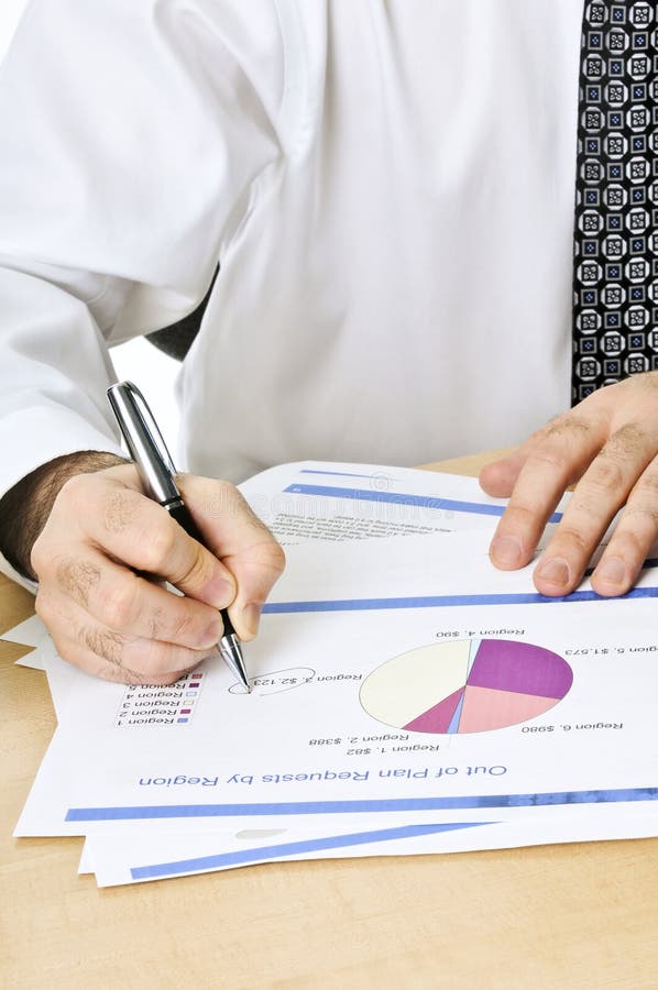 Office Worker Writing on Reports Stock Photo - Image of paper, charts ...