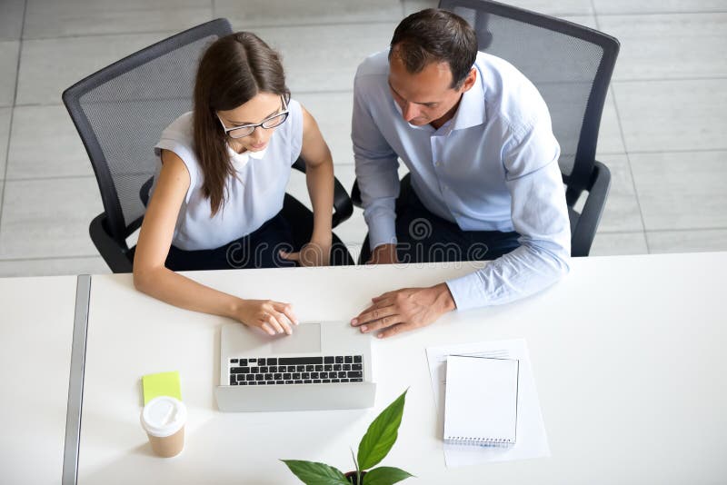Office Workers Discussing Project Working Together Using Laptop, Stock ...