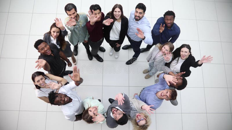 Office Workers and Foreign Employees Stand and Wave in the Office Lobby ...