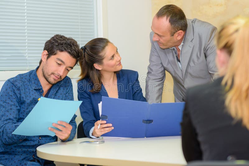 Office Workers Looking at Files Stock Image - Image of smile, female ...