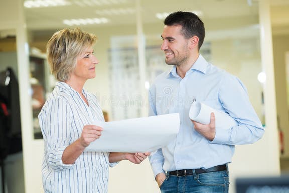 Office Workers Looking at Paperwork Stock Photo - Image of togetherness ...
