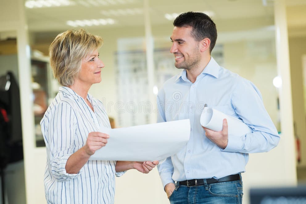 Office Workers Looking at Paperwork Stock Photo - Image of togetherness ...