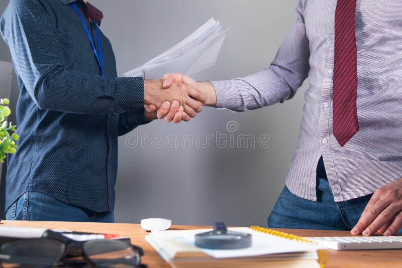 Office Workers Shaking Hands at the Desktop Stock Image - Image of ...