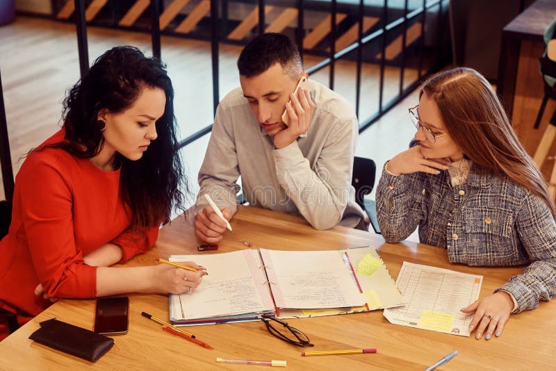 Office Workers, Sitting at Documents, the Girls are Working, the Guy is ...