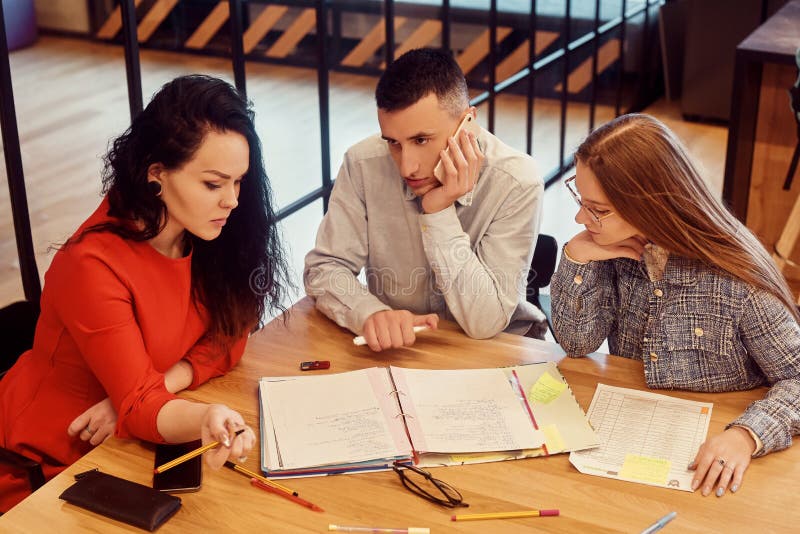 Office Workers, Sitting at Documents, the Girls are Working, the Guy is ...