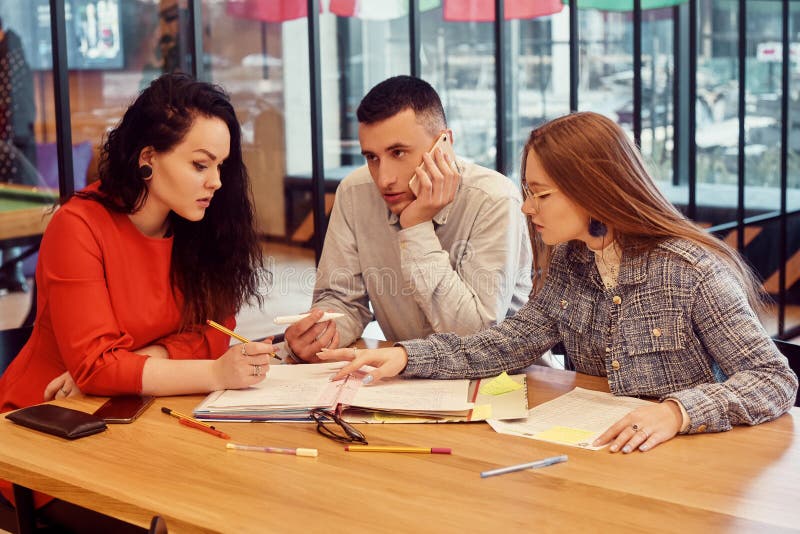 Office Workers, Sitting at Documents, the Girls are Working, the Guy is ...