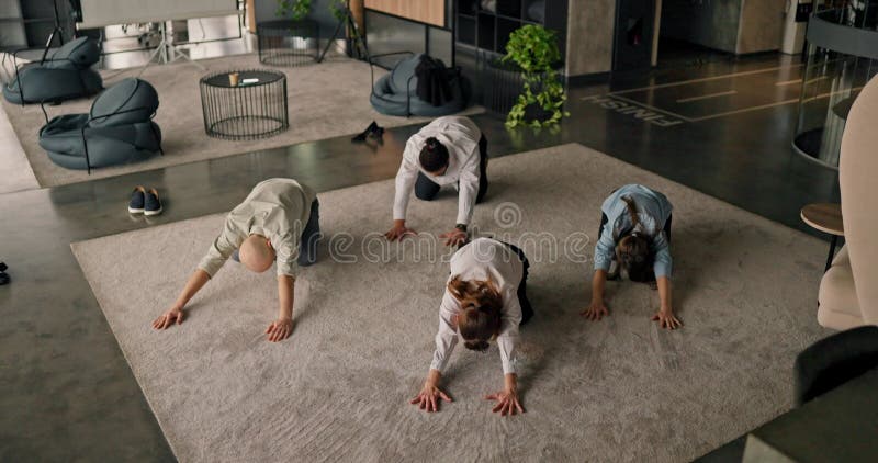 Office Workers Stretch Their Backs and Practice Cobra Pose on a Carpet ...