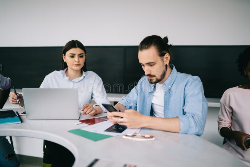Office Workers Using Gadgets while Working Together at Project Stock ...