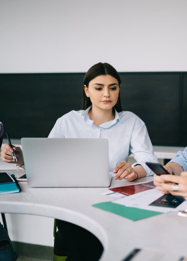 Office Workers Using Gadgets while Working Together at Project Stock ...