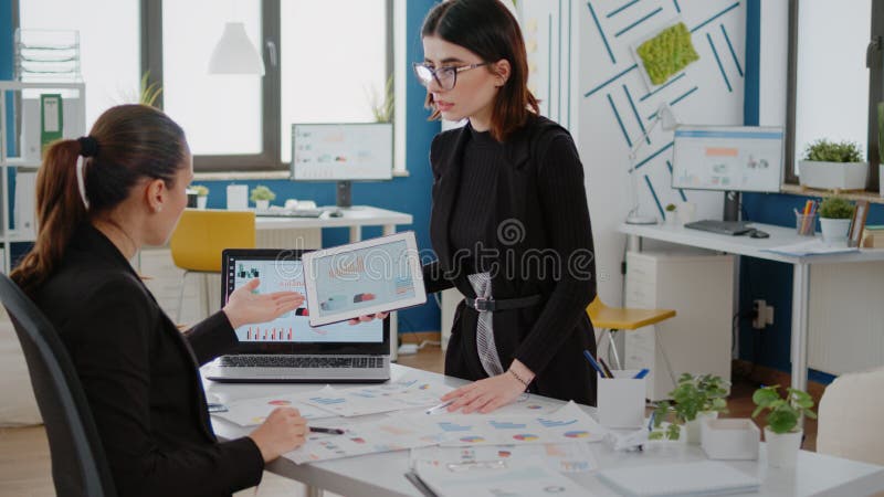 Office Workers Using Laptop and Tablet with Data Charts Stock Image ...