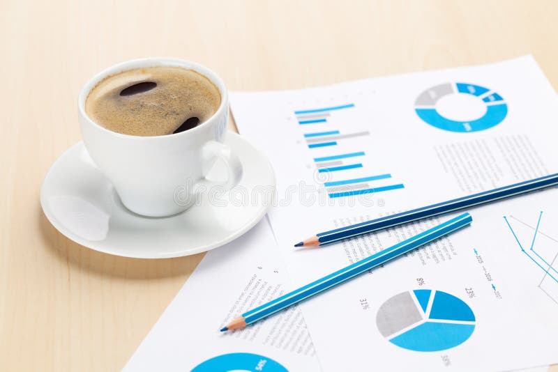 Office Workplace with Coffee Cup and Charts Stock Photo - Image of ...
