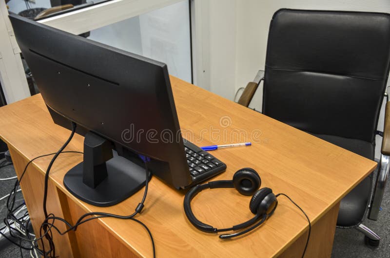 Office Workplace with Computer, Keyboard, Pen and Headphones with a ...