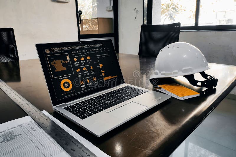 Office Workplace with a Laptop, Notes, and a Hard Hat on a Conference ...