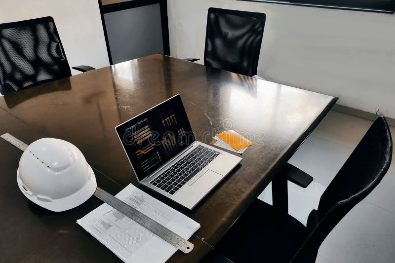 Office Workplace with a Laptop, Notes, and a Hard Hat on a Conference ...