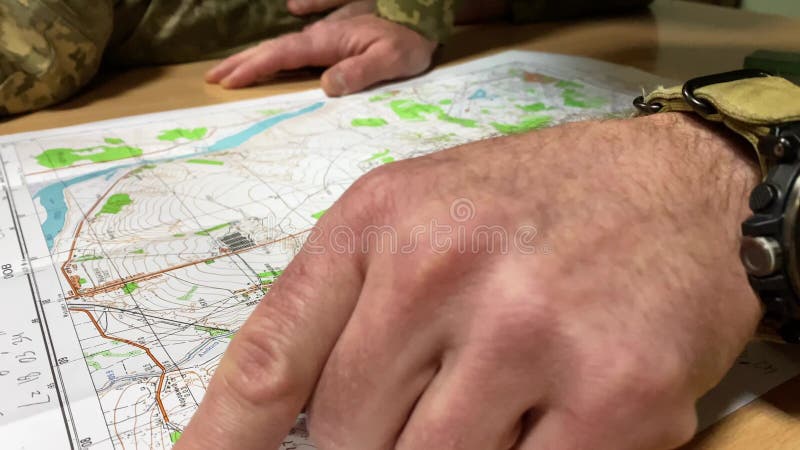 Officer Shows Important Objects on the Map with His Hand with Watch ...