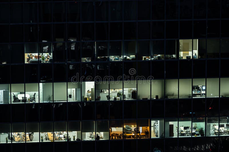 At Sunset, Lights are Turned on on the Glass Windows of Buildings in ...