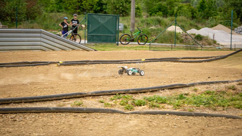 Yellow Electric RC Buggy Racing on an Offroad Track Stock Photo - Image ...