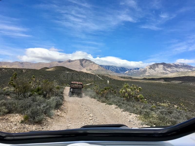 Off-road Vehicle Driving Down a Dirt Trail in the Desert Stock Photo ...