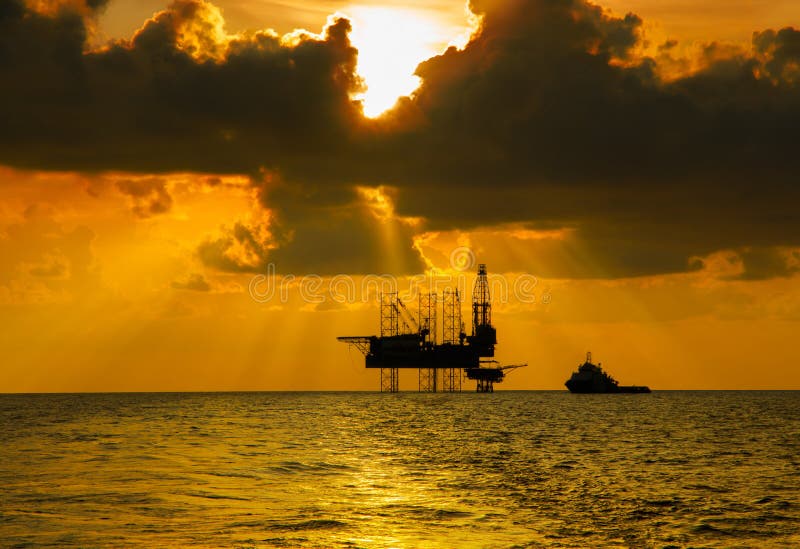 Offshore Jack Up Rig in the Middle of the Sea at Sunset Time Stock ...