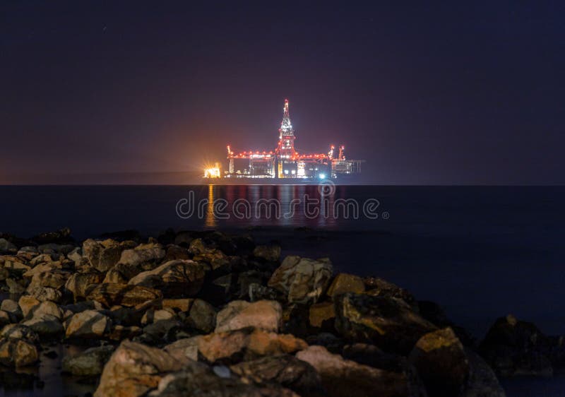 Offshore Oil Platform at Night with Lights Reflected in the Water Stock ...